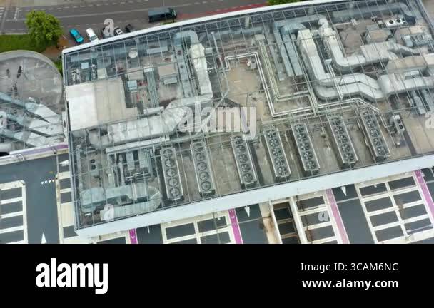 An aerial drone captures a top-down tilt over a commercial building ...