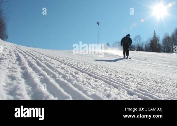 Group of young experienced skiers ski jump downhill enjoy winter sunny ...