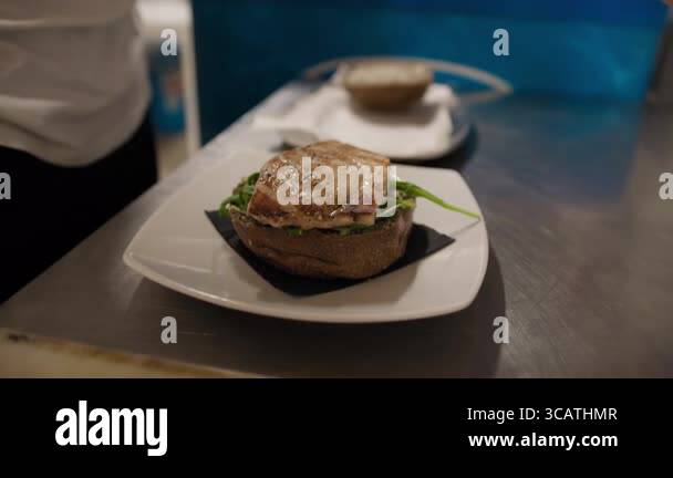 Chef Adding Mozzarella On Top Of The Grilled Swordfish Burger Dish ...