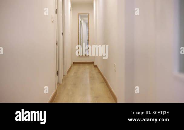Young boy running with infectious joy along white-walled corridor ...