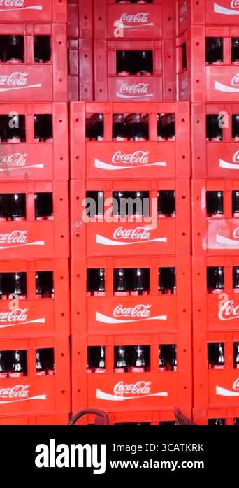 The stacks of red crates display various beverages for customers to see ...