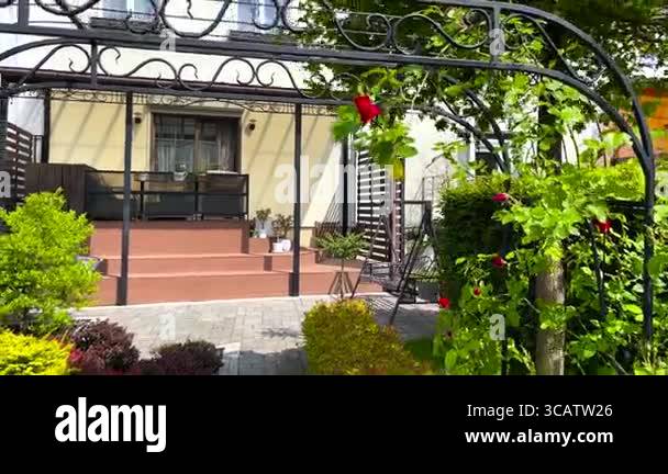 Backyard terrace with polycarbonate canopy. Forged arch with roses ...