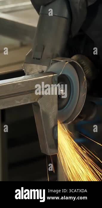 Grinding of metal products. close-up. A man in gloves grinds metal ...