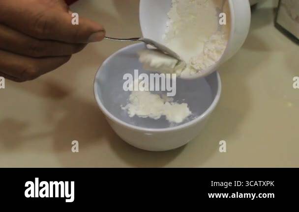 A bowl of flour mixed with water. Add water to the bowl containing the ...