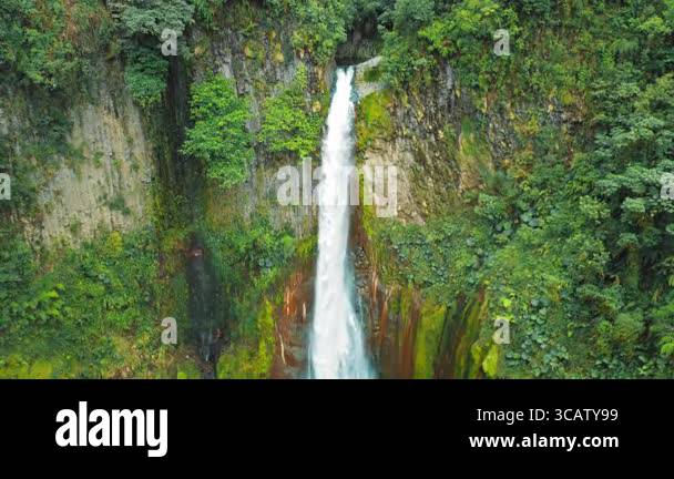 Tall waterfall Catarata del Toro flowing from hidden cave in lush Costa ...