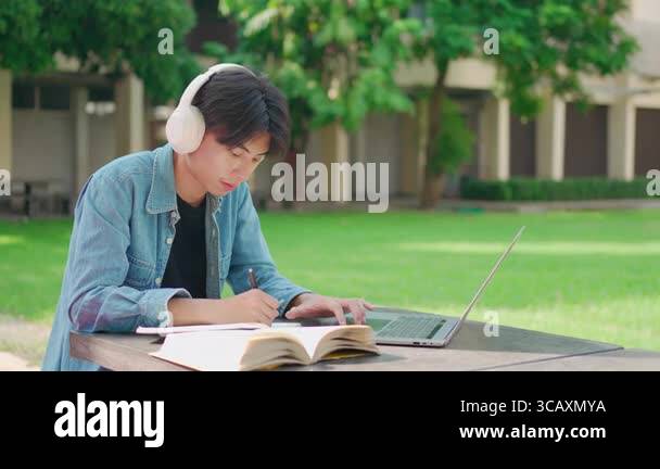 University student on campus using laptop for online learning, review lesson and digital study ...
