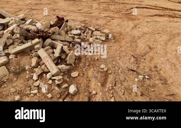Construction debris scattered in a unique way on the sandy soil forming ...