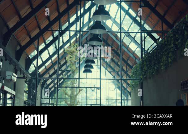 A spacious interior of a modern caf featuring a high, slanted roof with ...