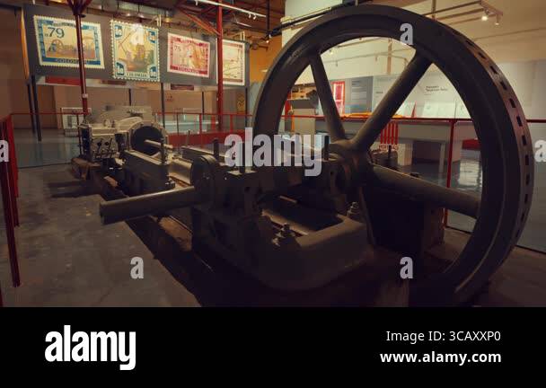 A vintage industrial machine displayed in a museum, featuring large ...