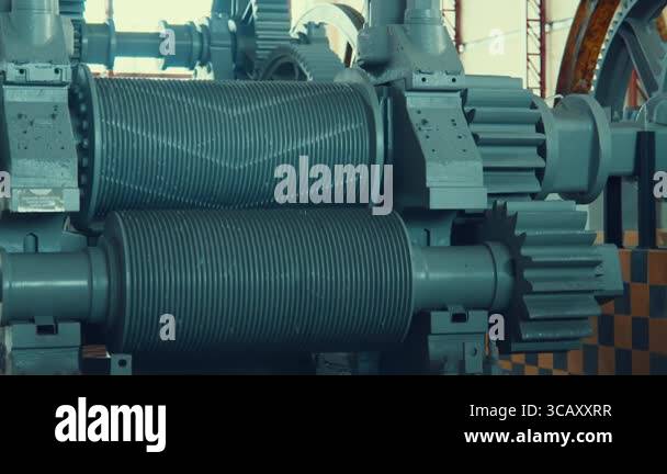 Close-up view of industrial machinery with large cylindrical rollers ...