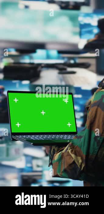 Vertical Video Black military personnel uses green screen on pc in ...