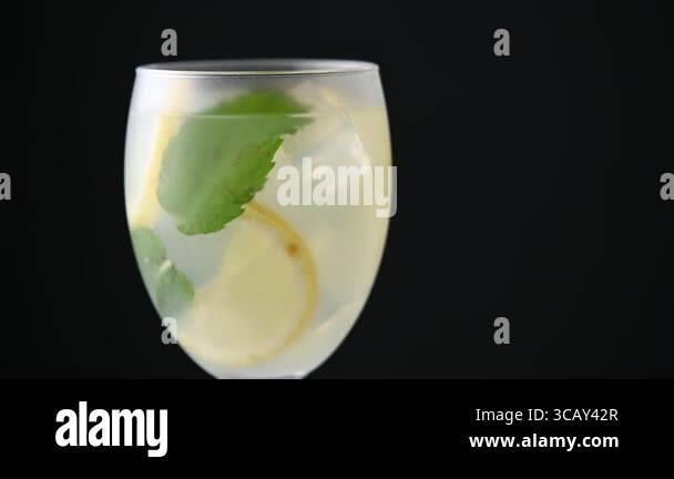 Rotating Hugo Spritz cocktail in glass on black background Stock Video ...