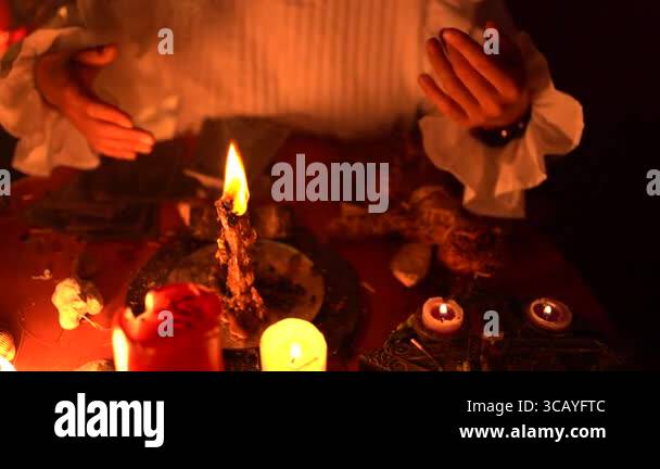 Mystical ritual with burning candles, tarot cards, and a person s hands ...