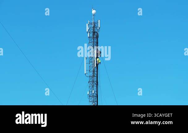 KYIV, UKRAINE, MARCH 22, 2025: Two workers repair cell tower. Laying ...
