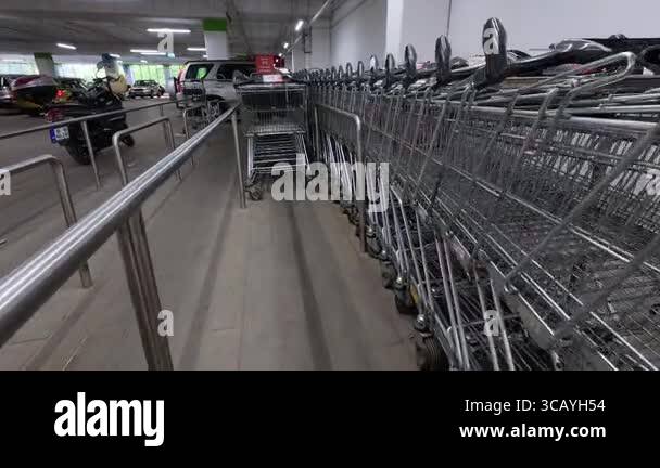 Low-angle view of shopping carts lined up in an underground parking ...