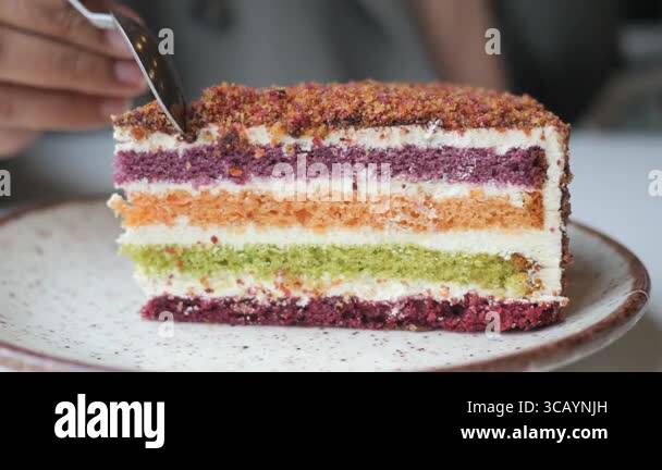 A slice of multilayered cake displays bright colors and textures Stock ...