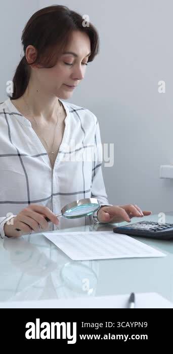 Accountant examining financial reports using magnifying glass ...