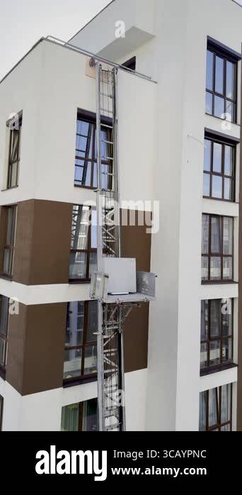 Exterior furniture elevator lifting platform to high building window ...