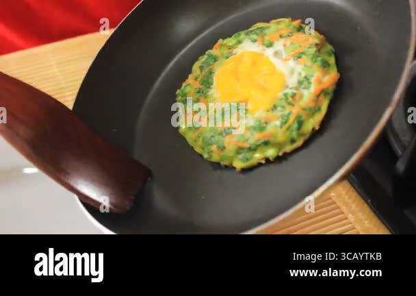 flip vegetable egg. egg cooking in a frying pan Stock Video Footage - Alamy