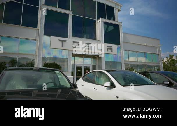 Exterior of Tesla dealership with parked electro mobiles. The ...