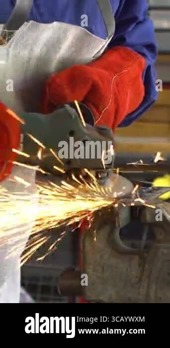 Slowmotion of metal processing with a man using angle grinder to ...