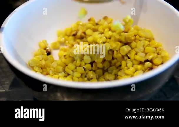 Bowl spoon corn Yellow corn in hot pot boiler. Cooking vegetables in a ...