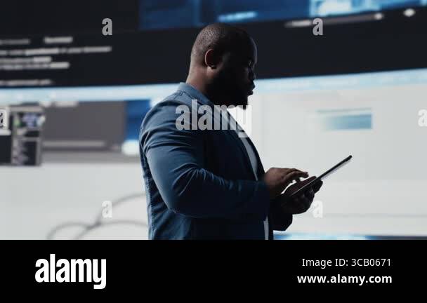 African american coder expert immersing in software development for a high tech work environment ...