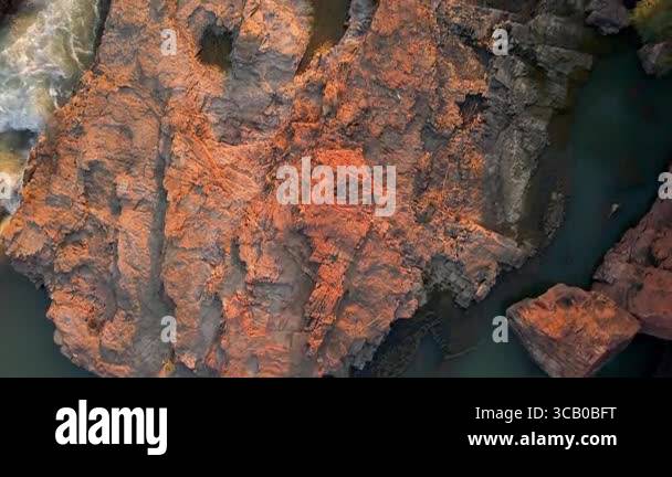 Stunning aerial shots of rocky formations and rushing water in a ...