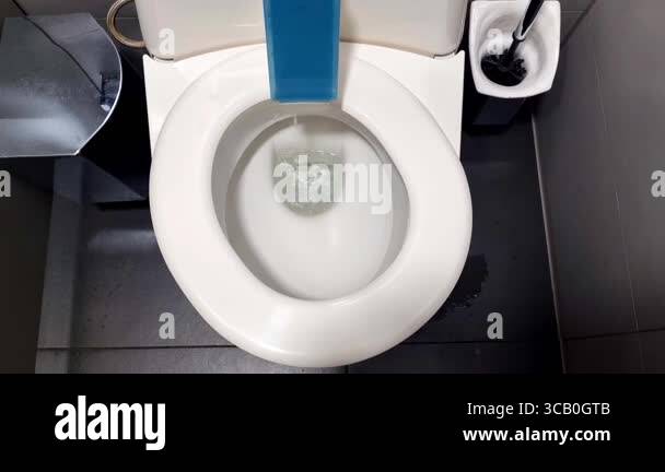 Modern restroom featuring a close-up view of a toilet with a flushing ...