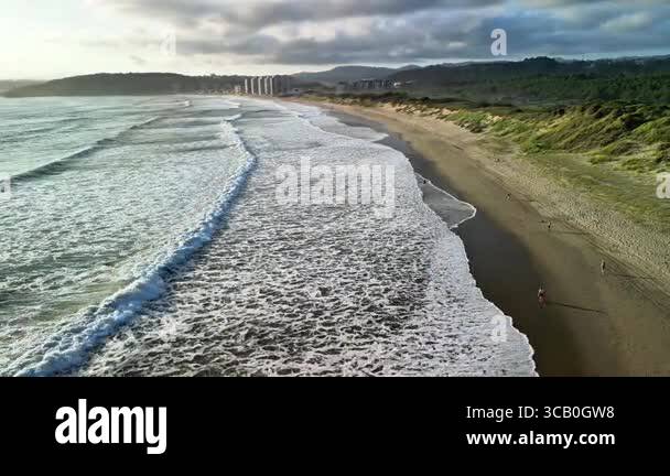A stunningly beautiful beach scene captures gentle waves rolling onto ...