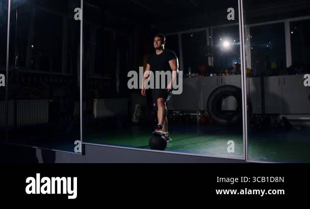 In a dim boxing ring, a determined man displays his skills in an ...