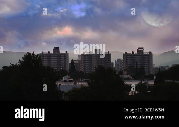 Hazy cityscape with high-rise buildings and full moon. High quality 4k ...