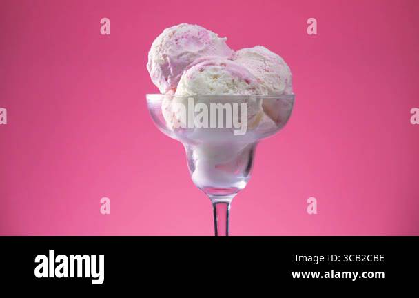 Sweet ice cream in a glass container slowly rotates around its axis ...