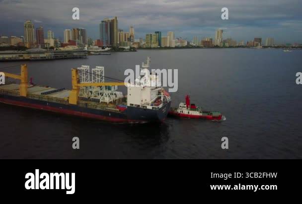 Aerial of Two Tugboats Pulling a Cargo Ship, Manila, Philippines Stock ...