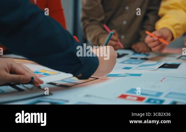 A close-up view of diverse designers engaging in creative collaboration ...