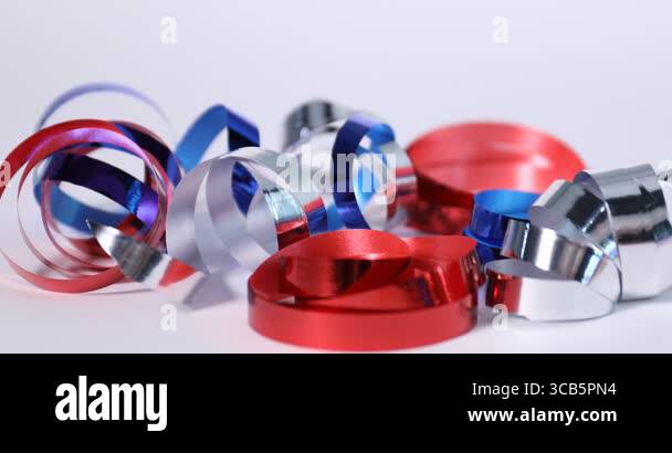 Shiny serpentine streamers falling on white background, closeup Stock ...