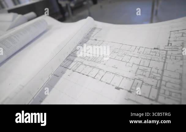 Open blueprints stretch across drafting table. Architectural layout ...