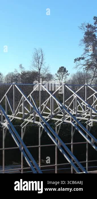 Metal framework of a large greenhouse under construction with ...