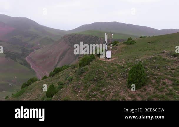 telecommunication tower in Chunkurchak mountain gorge before the storm ...