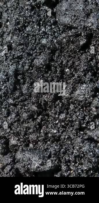 close-up, fresh asphalt in the process of laying on the road,, large ...