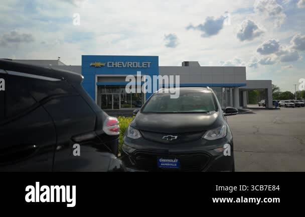 Exterior of Chevrolet dealership with parked cars. The dealership ...
