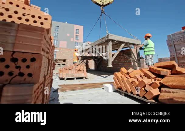 Construction Workers Positioning Suspended Platform, Brick Stacks and ...