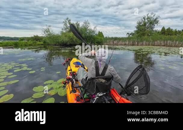 Kayak paddle at lake or pond during fishing game sport action ...