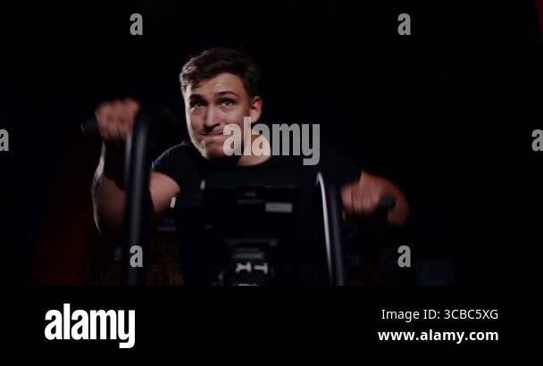 In a dim boxing ring, a determined man displays his skills in an ...