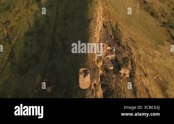 Aerial top view of an ancient stone watchtower standing alone on a ...
