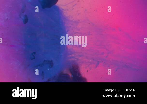 Vertical video. Defocused dripping. Diamond gemstone. Pink purple fluid ...