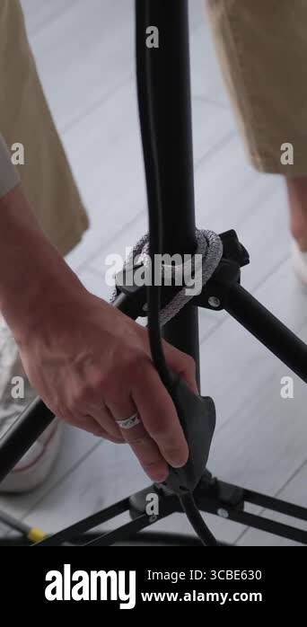 Vertical video. Operator light. Turning spotlight. Man activate ...