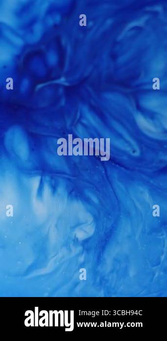 Vertical video. Ink bleed. Dye explosion. Liquid art boiling white blue ...