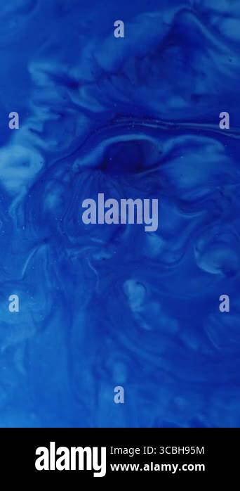 Vertical video. Marbling enamel. Paint emulsion. Art blue blobs spill ...