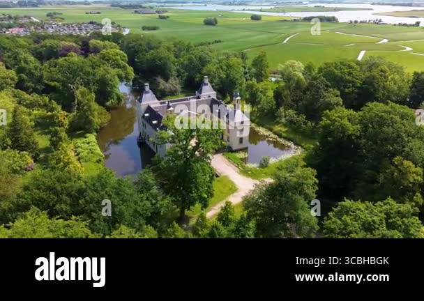 Aerial view of a historic castle surrounded by a forest, with vast ...
